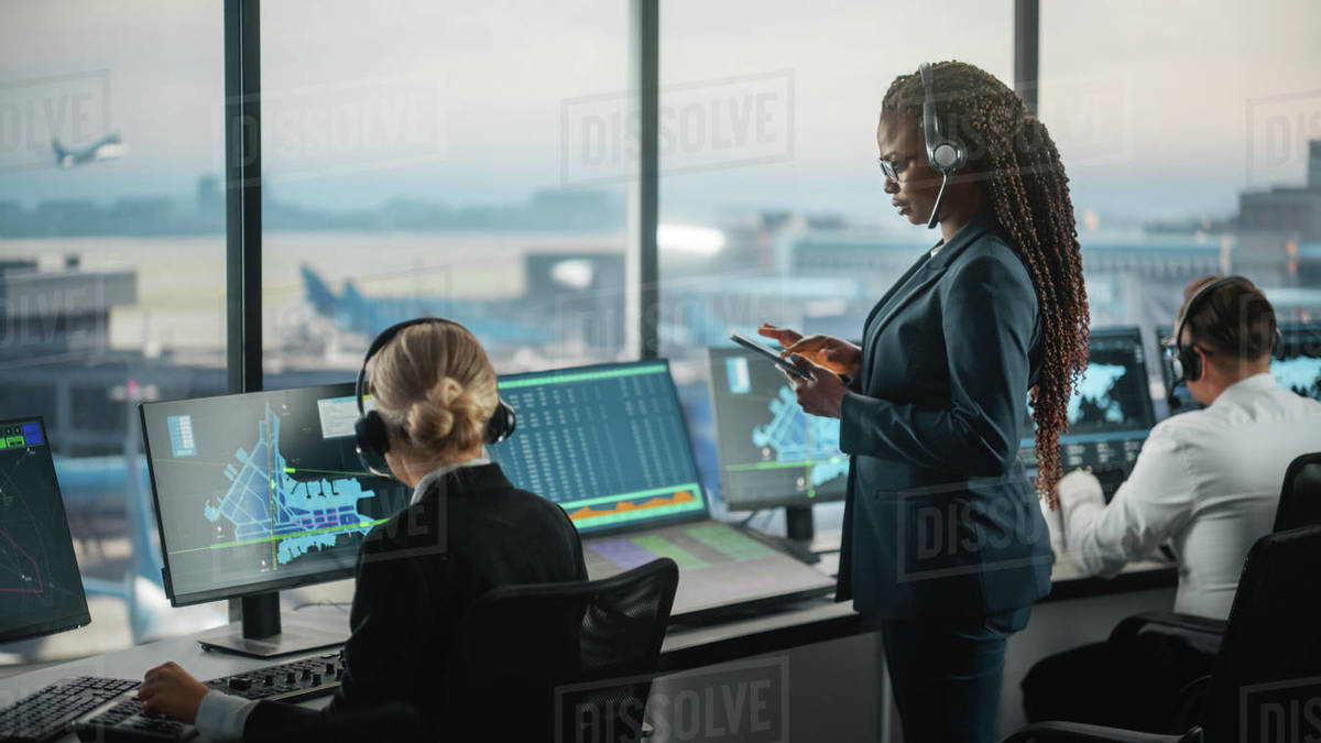 Diverse Air Traffic Control Team Working in a Modern Airport Tower ...