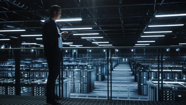 Portrait of IT Specialist Using Tablet Computer in Data Center. Cyber ...