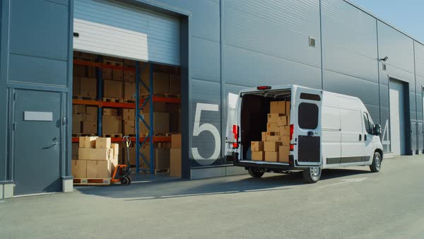 Outside of Logistics Warehouse with Open Door, Delivery Van Loaded with ...