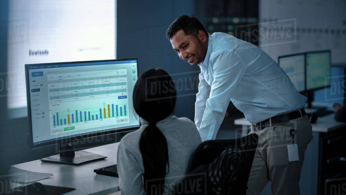 Two Professional Traders Talking and Working in a Modern Monitoring ...