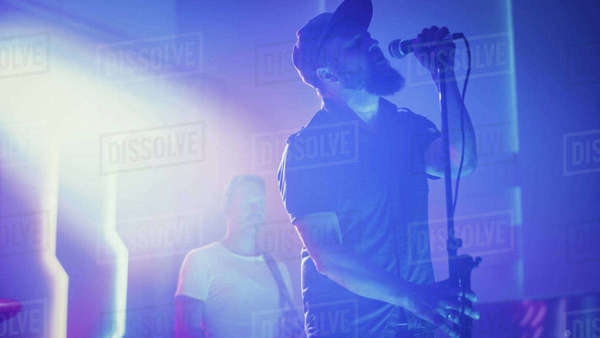 Rock Band Performing at a Concert in a Night Club. Portrait of a Lead ...