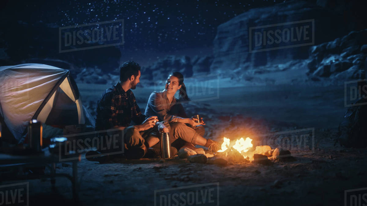 Happy Couple Nature Camping in the Canyon, Sitting by Campfire ...