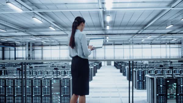 Data Center Engineer Using Laptop Computer. Server Farm Cloud Computing ...