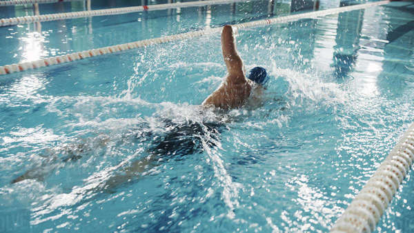 Male Swimmer Swimming in Olympic Pool. Professional Athlete Performing ...