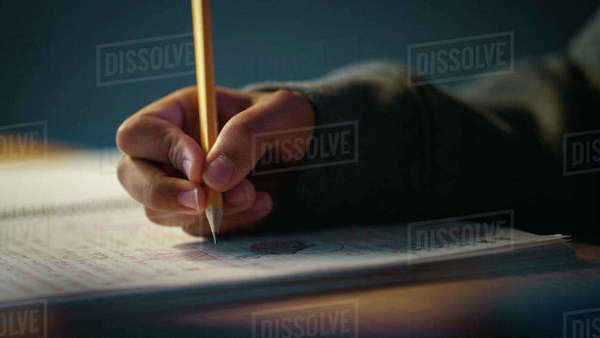 Close Up Shot of a Young Person Writing with Pencil in Notebook - Stock ...
