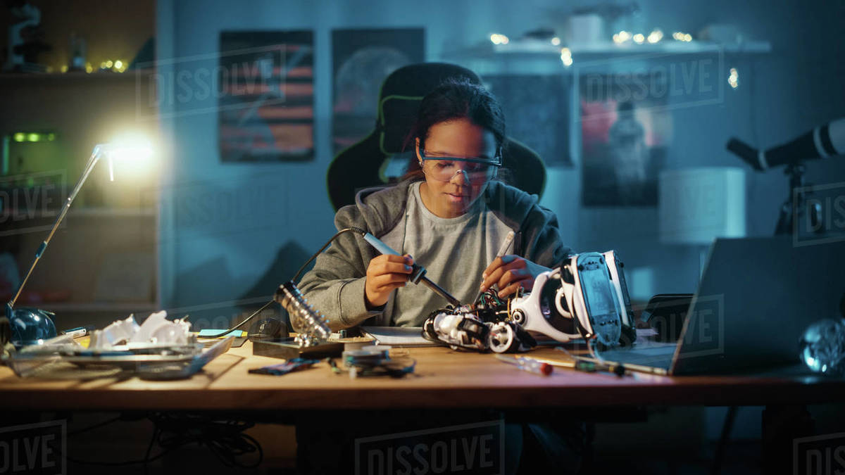 Young Teenage Schoolgirl is Studying Electronics and Soldering Wires ...