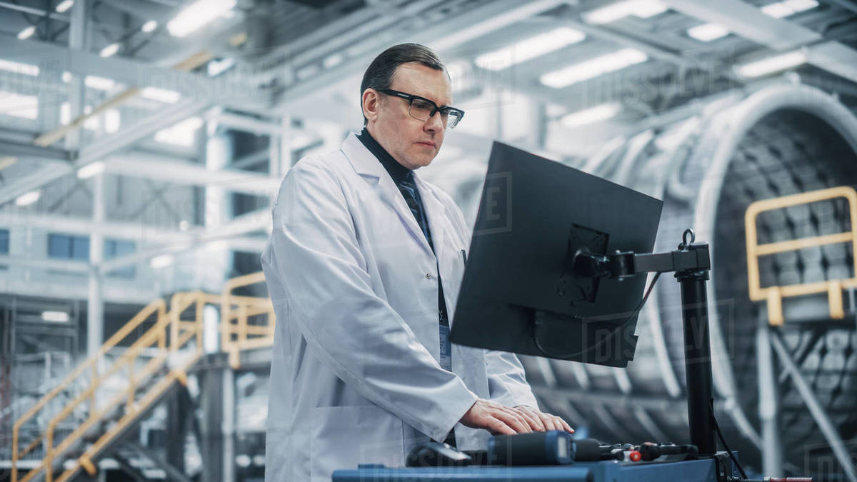 Professional Male Heavy Industry Engineer/Worker Working on a Computer ...