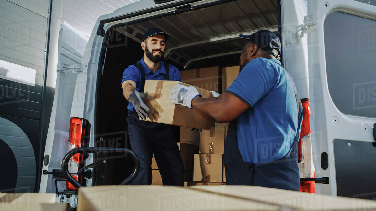 Two Workers use Hand Pallet Truck Loading Delivery Truck with Cardboard ...