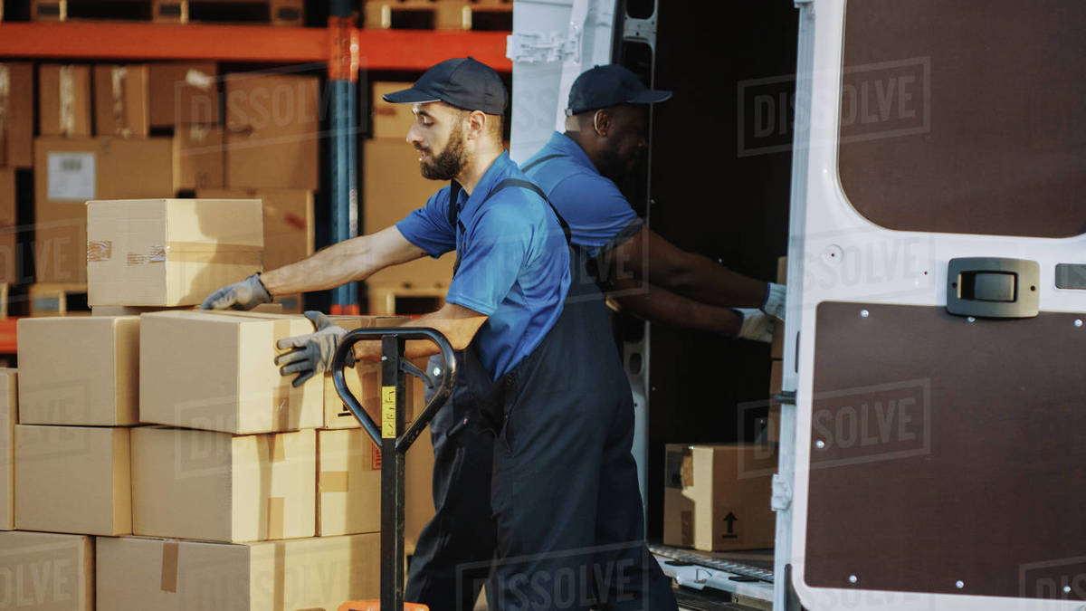 Diverse Team of Two Workers Loading Delivery Truck with Cardboard Boxes ...