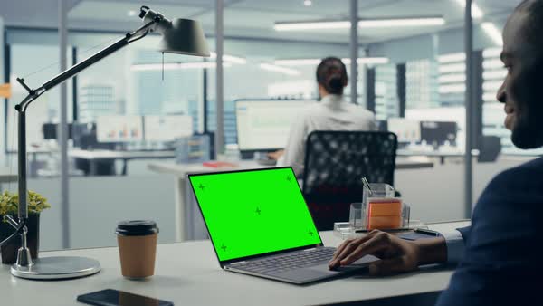 Black Businessman Sitting at Desk Working on Green Screen Chroma Key ...