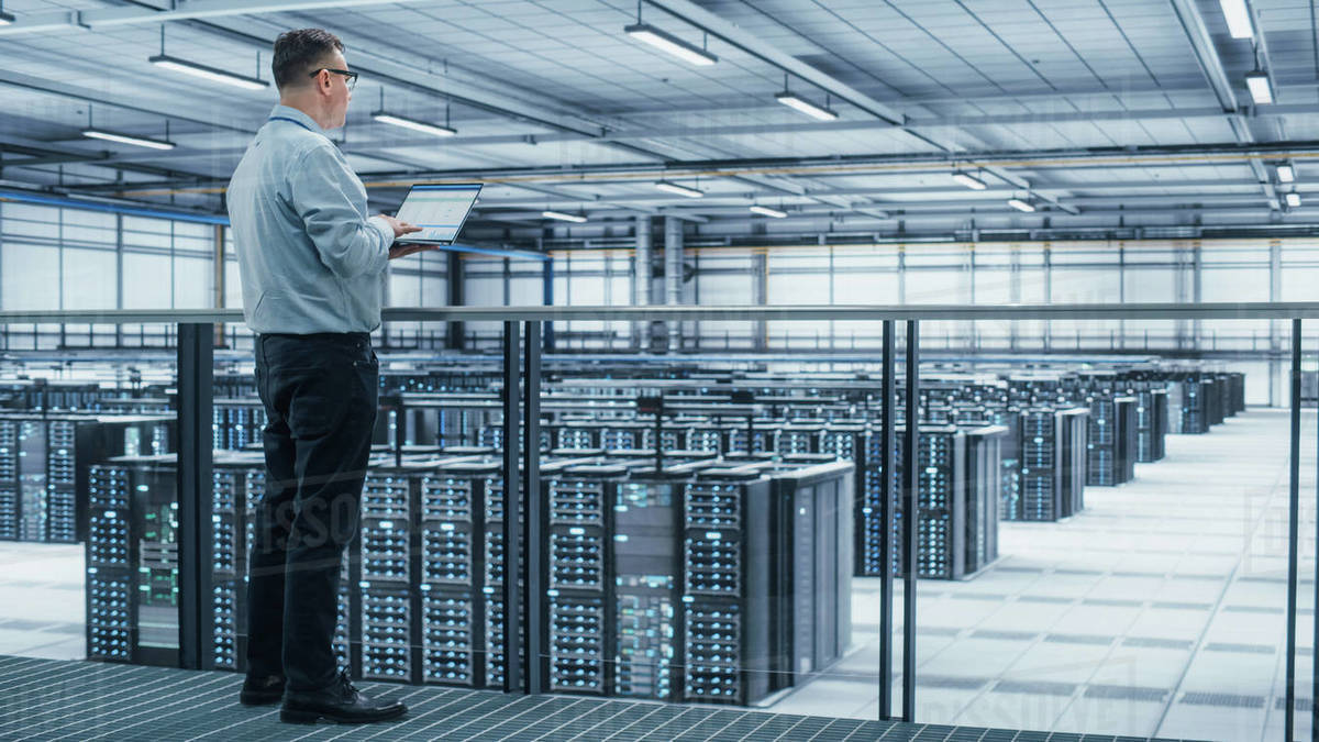 Data Center Engineer Using Laptop Computer - Stock Photo - Dissolve