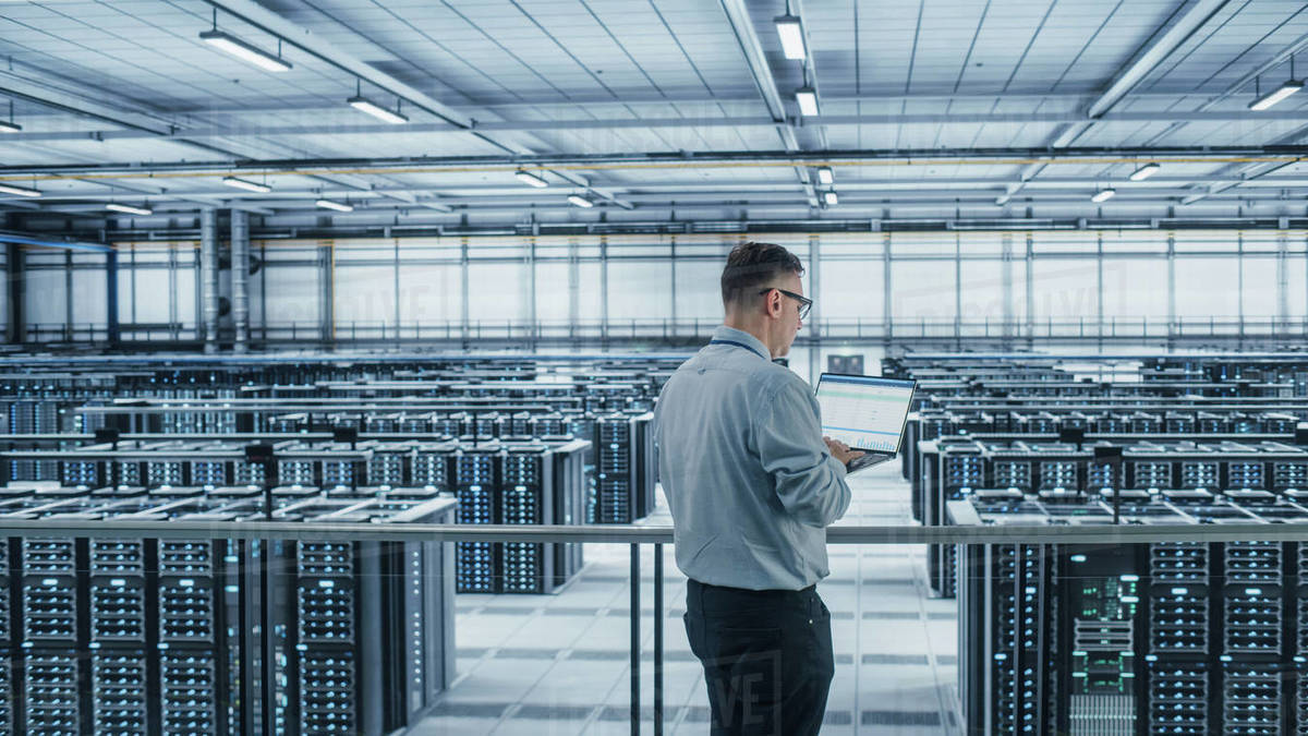 Data Center Engineer Using Laptop Computer - Stock Photo - Dissolve