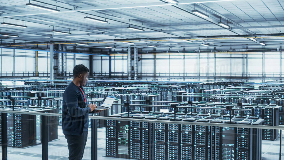 Data Center Engineer Using Laptop Computer - Stock Photo - Dissolve
