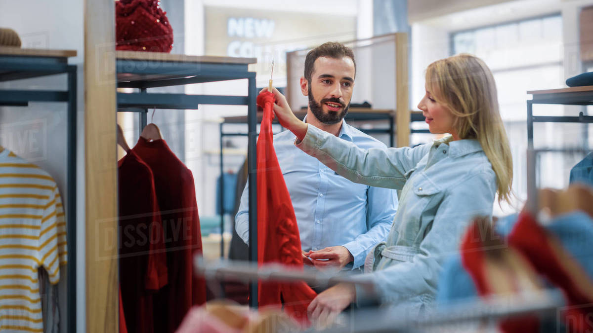 Female Customer Shopping in Clothing Store - Stock Photo - Dissolve