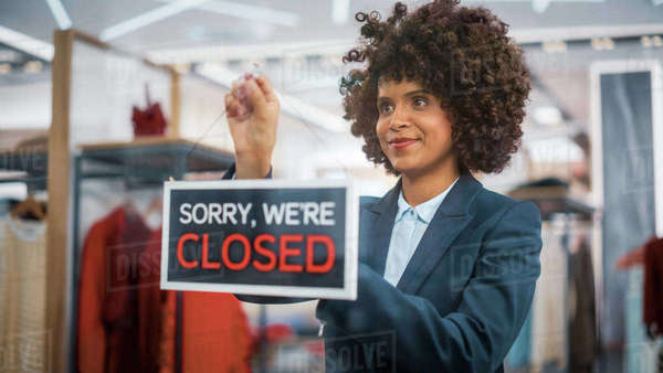 African American Clothing Shop Manager Changes Fashion Store Sign on ...