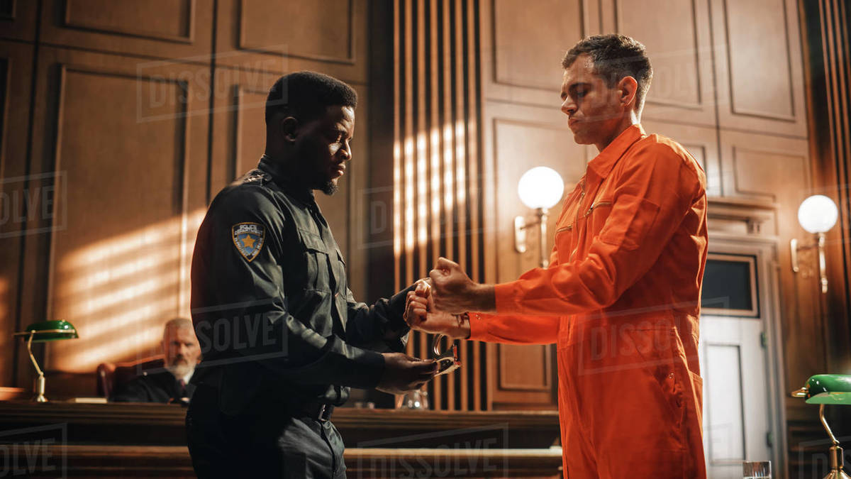 Male Criminal in Orange Jumpsuit Handcuffed and Led Away by Security ...