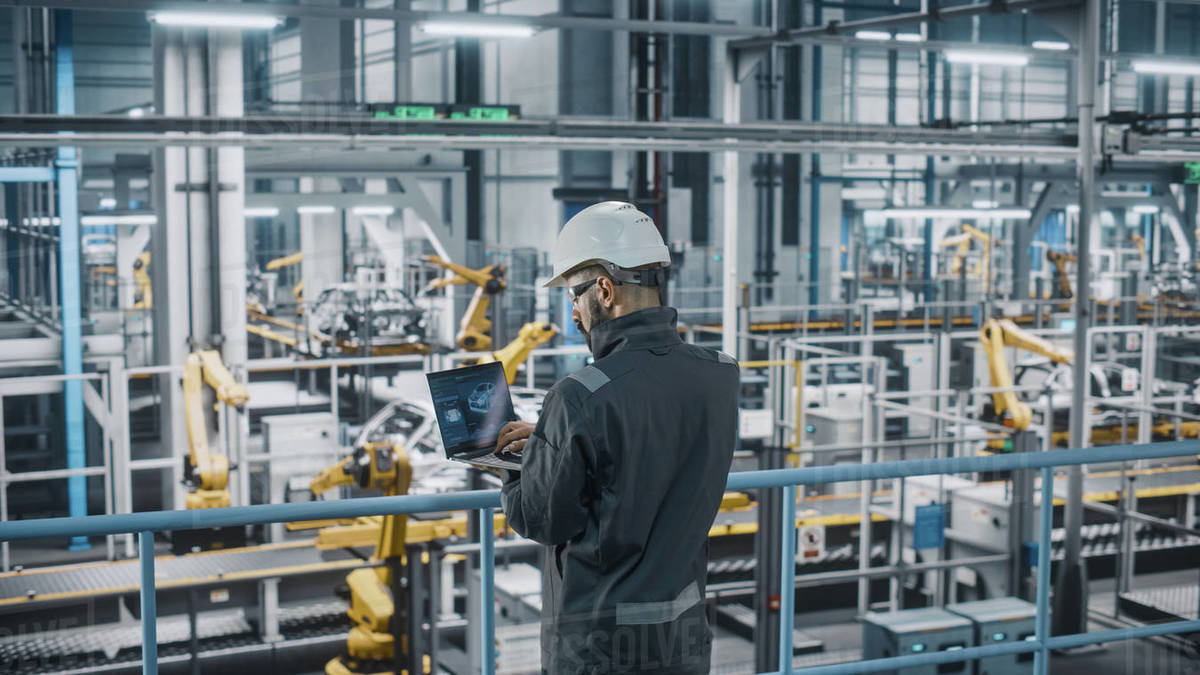 Car Factory Engineer in Work Uniform Using Laptop Computer - Royalty ...