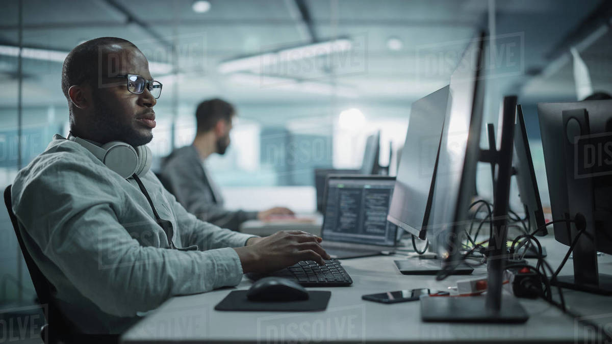 Authentic Office: Enthusiastic Black IT Programmer Starts Working on Desktop Computer. Male ...