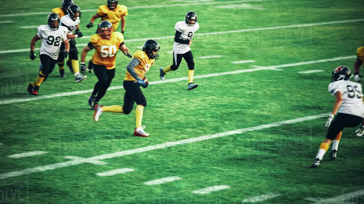 American Football Teams Start Game - Stock Photo - Dissolve