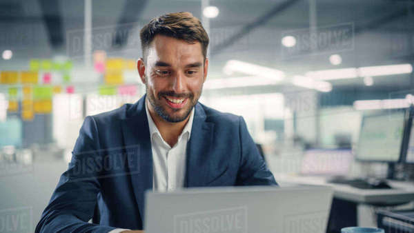 Young Businessman Using Laptop Computer in Modern Office - Stock Photo ...