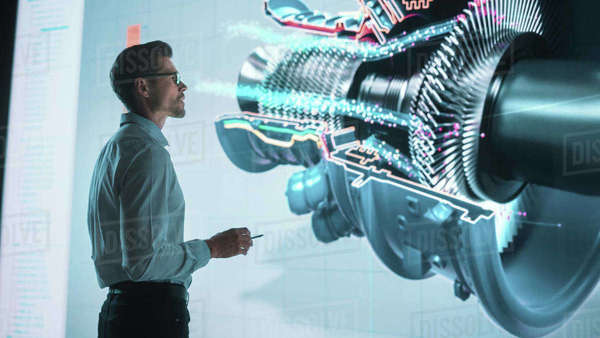 Engineer Designing Engine Using Tablet Computer and Big Wall Screen to ...