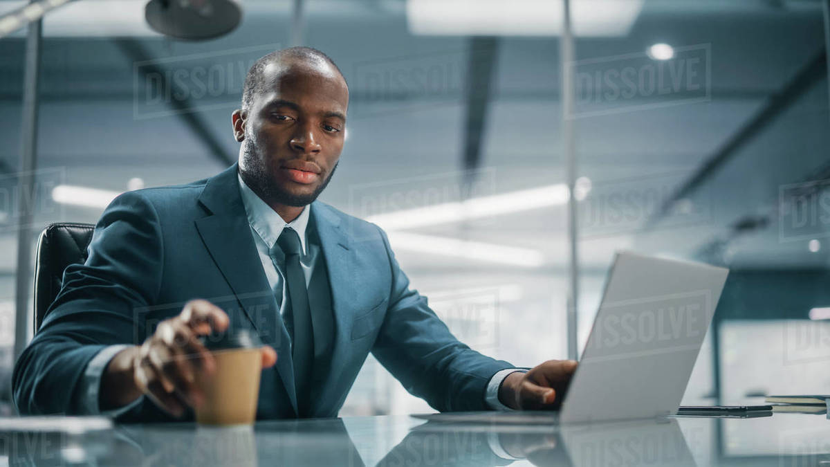 Black Businessman in Tailored Suit Working on Laptop Computer - Royalty ...