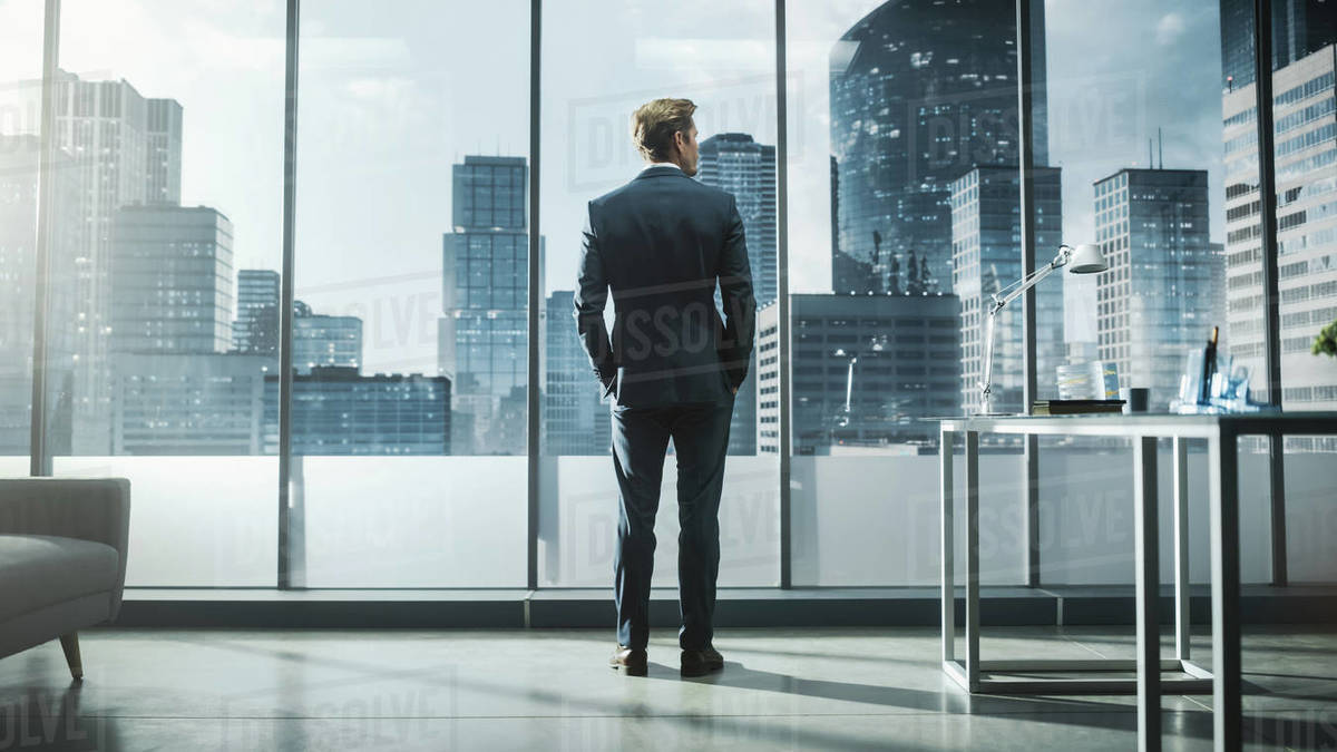 Businessman Standing Next to a Window in a Modern Office - Royalty-free ...