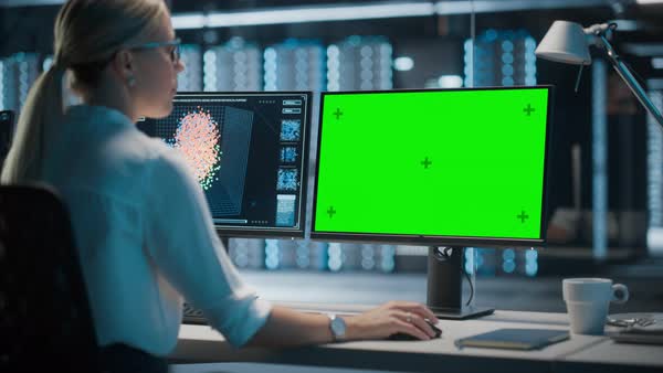 Female IT Specialist Working on Green Screen Chroma Key Computer ...