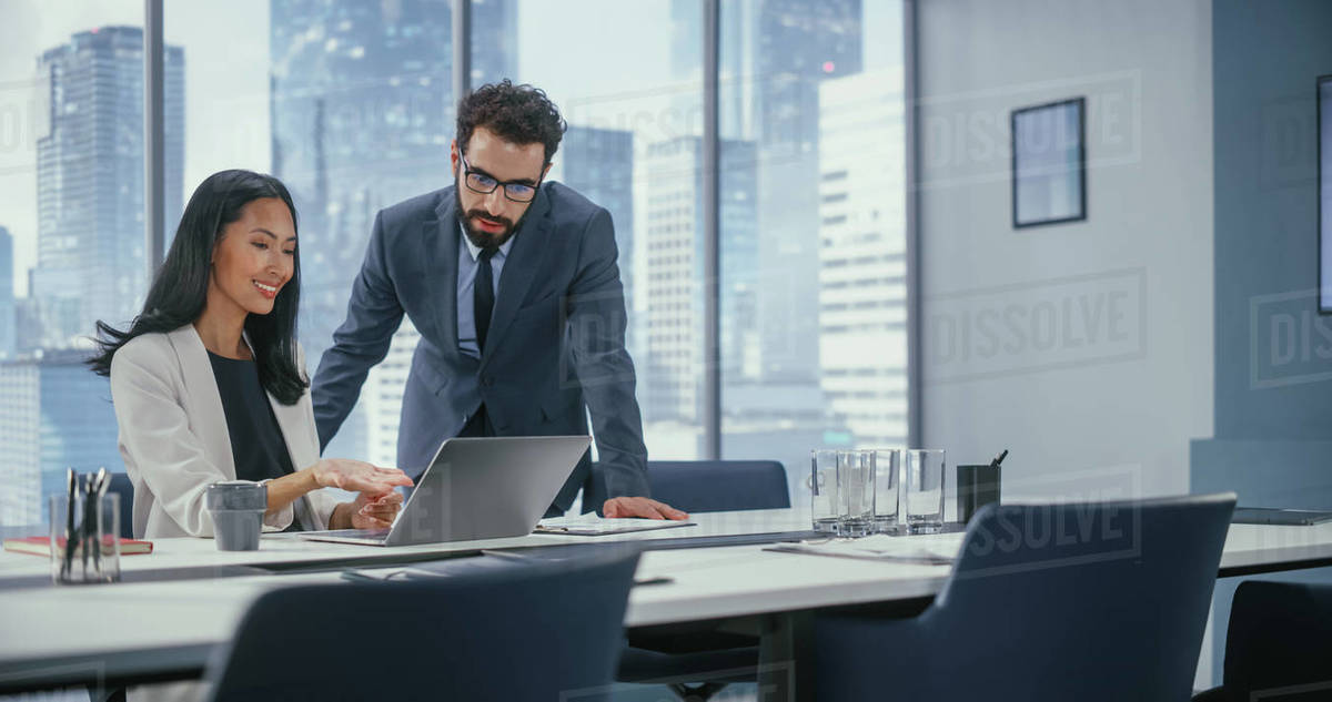 Corporate CEO Sitting at Her Desk Working on Laptop and Consulting Top ...