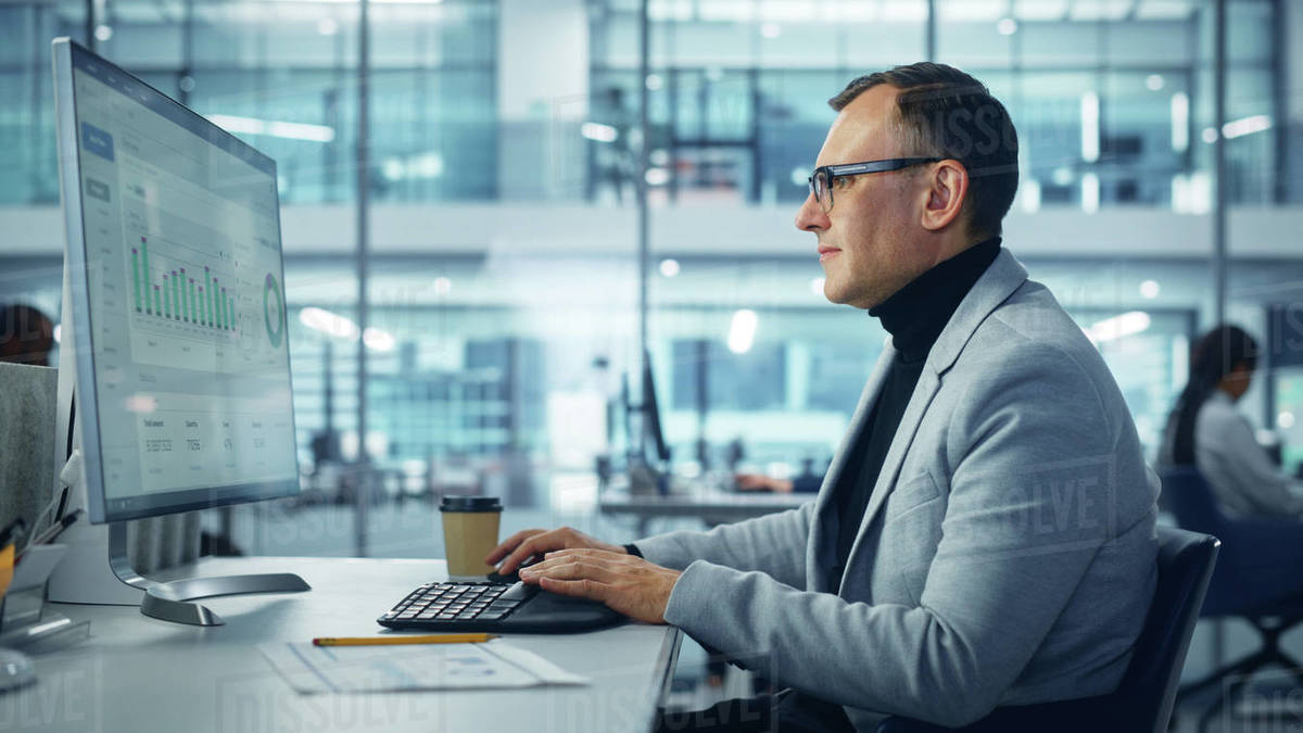 Big Data Engineer Using Desktop Computer - Stock Photo - Dissolve