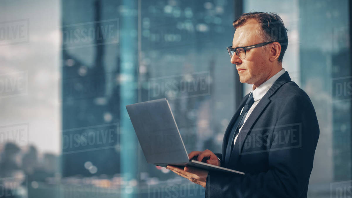 Businessman in a Suit Standing in Modern Office - Royalty-free Stock ...