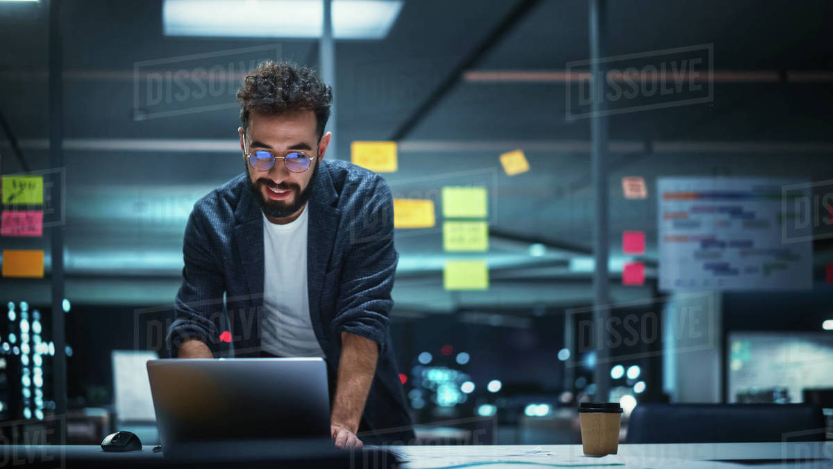 Successful Handsome Creative Director Working on Laptop Computer in Big ...