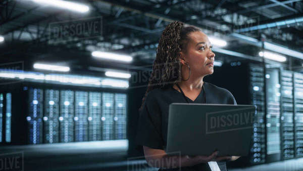 Mixed RaceFemale IT Specialist Uses Laptop Computer in Data Center ...