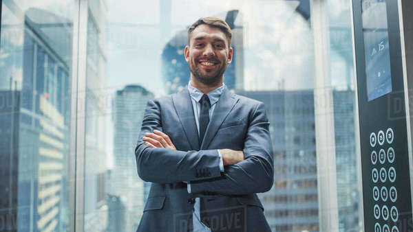 Portrait of a Successful Businessman in a Suit Riding Glass Elevator to ...