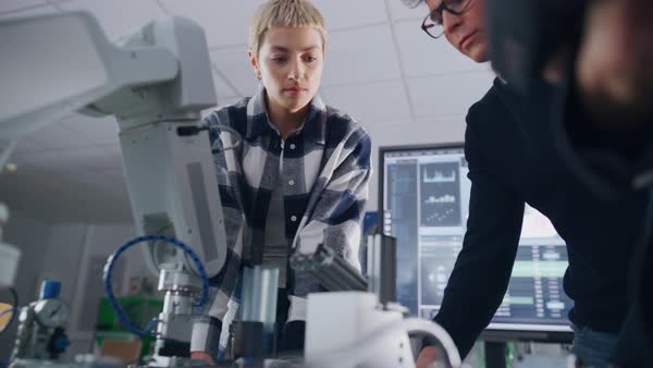 Students Gathering Around Bionic Robot Arm with Female Teacher and ...