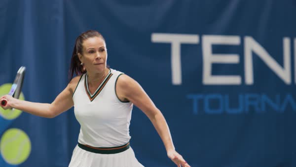 Female Tennis Player Hitting Ball with a Racquet During Championship ...