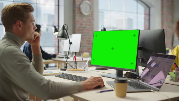 Portrait of White Creative Young Man Working on Green Screen Computer ...