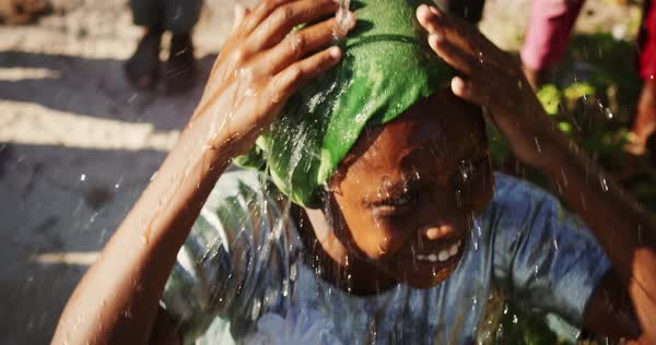 Portrait of an African Little Girl Jumping and Dancing Under Pouring ...