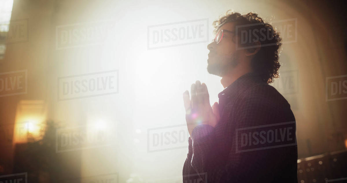 Young Christian Man Sits Piously in Majestic Church, with Folded Hands ...