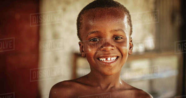 Portrait of a Smiling African Kid in a Rural Area Laughing and Looking ...