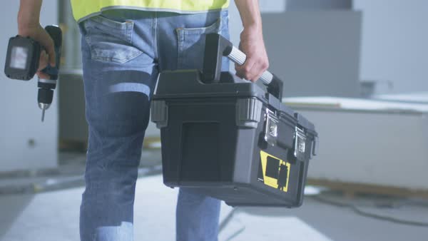 Construction worker walking inside building under construction and ...