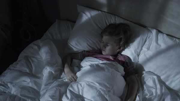 Medium high angle time lapse shot of boy having nightmares in bed - 4K ...