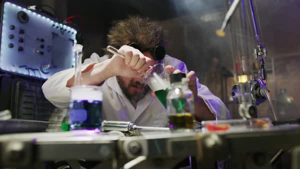 Nervous mad scientist mixing liquid in laboratory - 4K Rights-managed ...