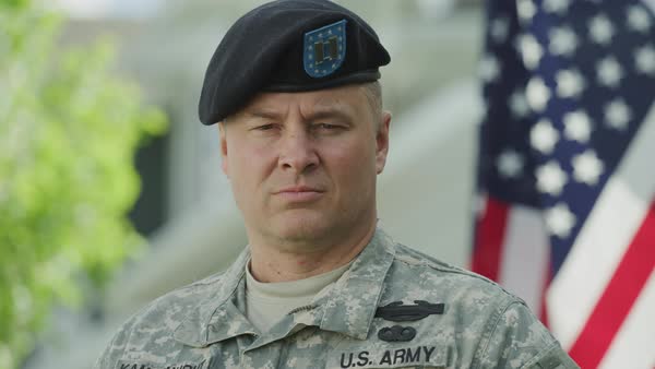 Close up portrait of confident army soldier near American flag - Stock ...