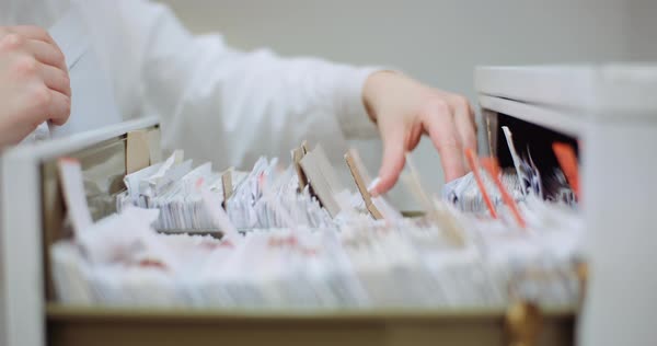 Female doctor looks for personal data in the file - Stock Video Footage ...