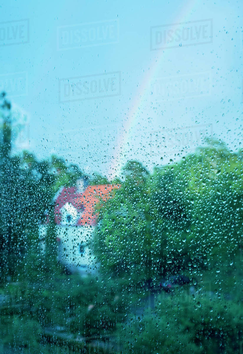 Rainbow seen through wet glass - Stock Photo - Dissolve