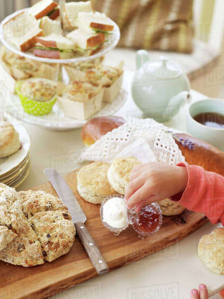 Childs hand holding jam - Stock Photo - Dissolve