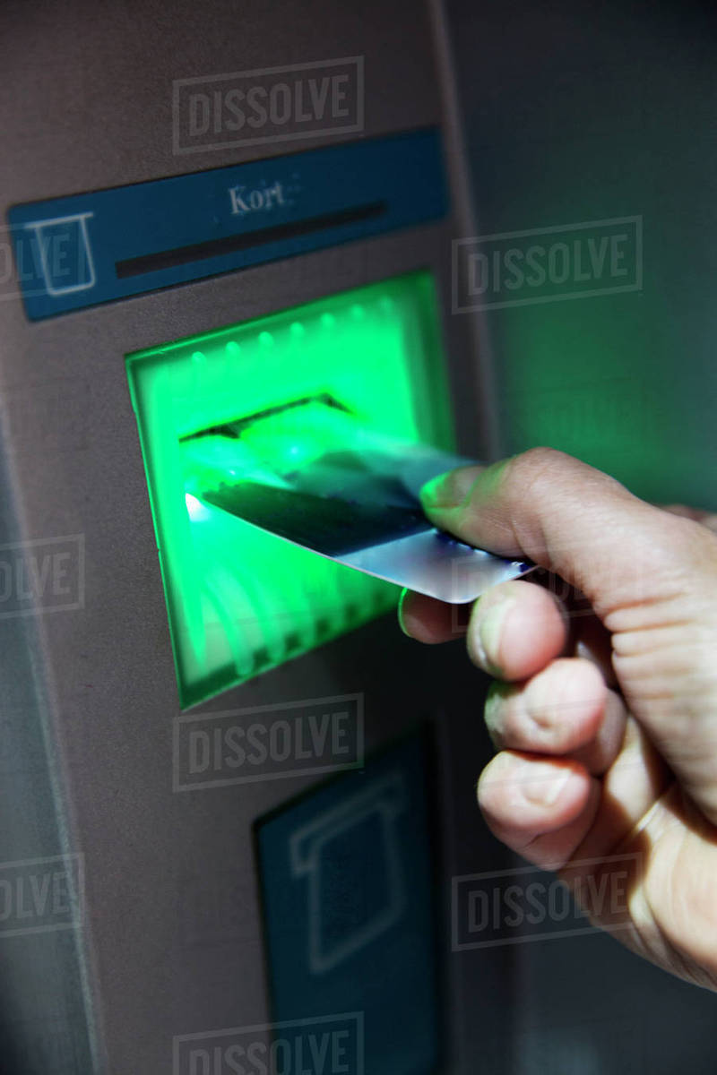 Hand putting bank card into cash machine - Royalty-free Stock Photo ...
