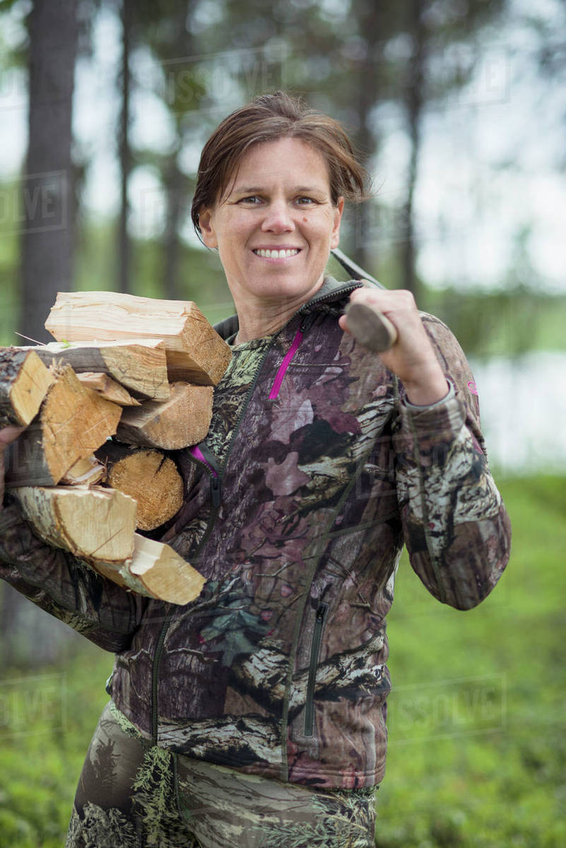 Woman carrying firewood - Royalty-free Stock Photo | Dissolve