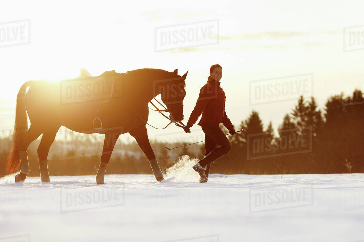 Woman walking with horse - Royalty-free Stock Photo | Dissolve